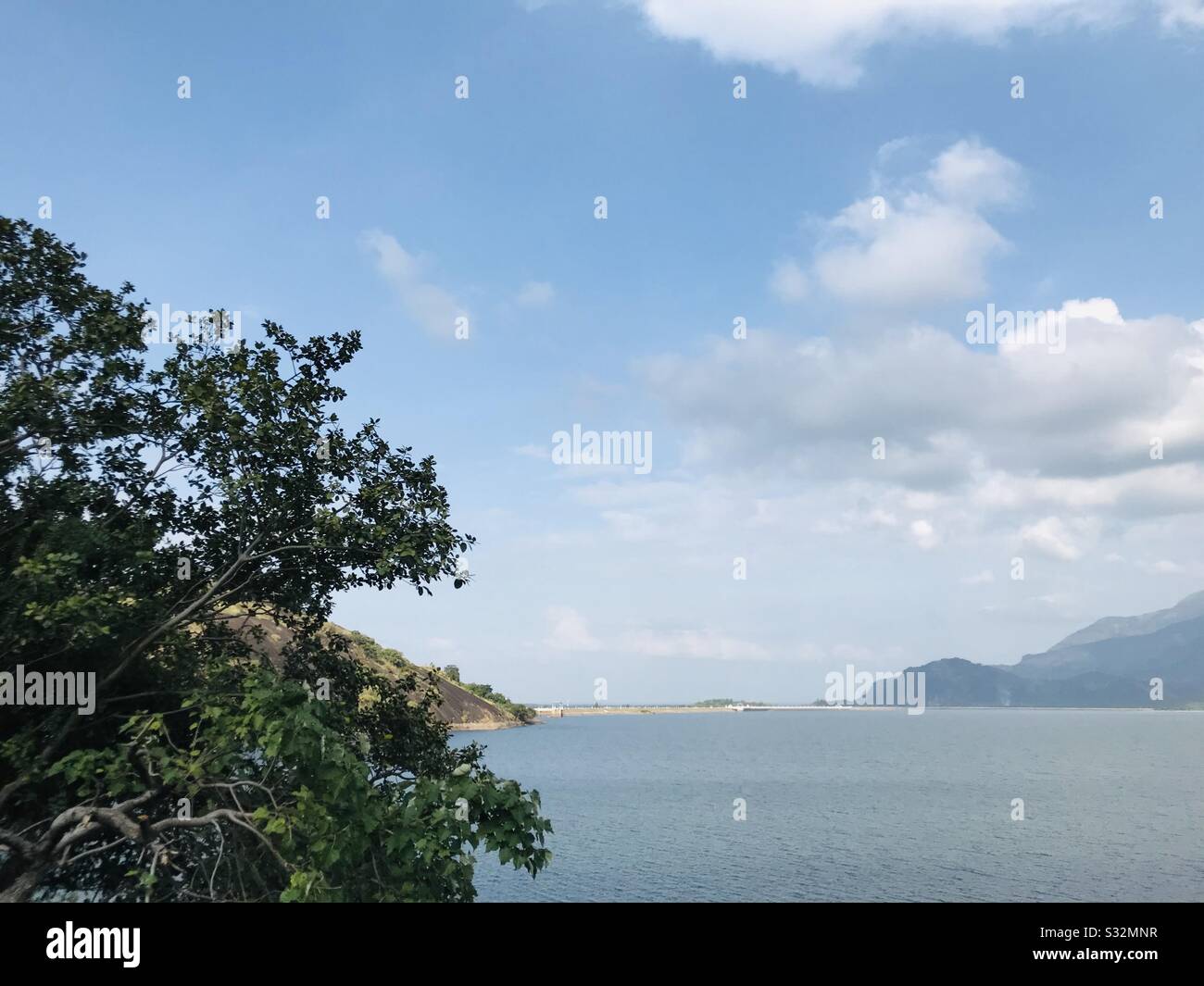 Aliyar dam, natural water reservoir with lush greenery and mountains ...