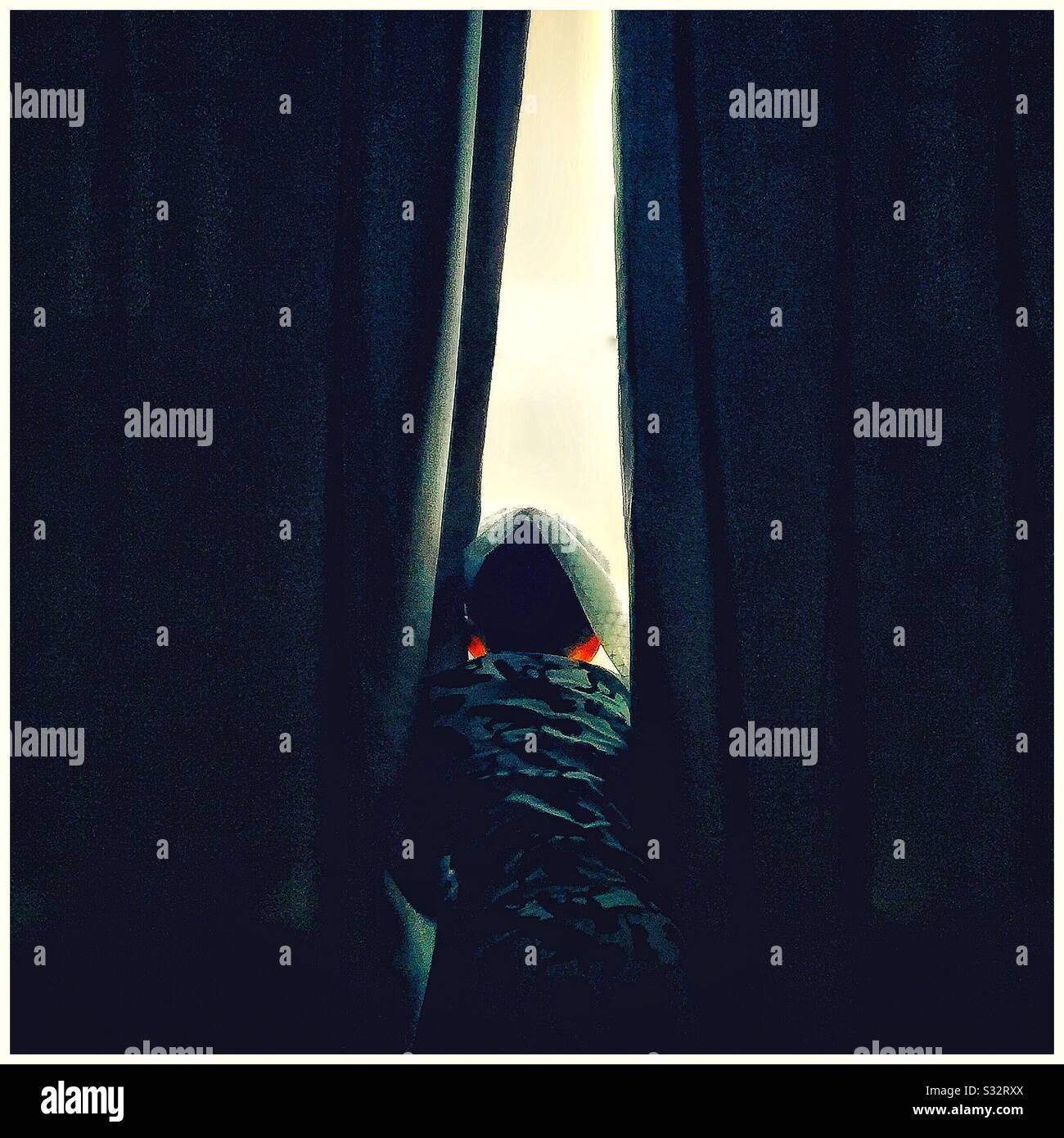 A child looking out of a window Stock Photo - Alamy