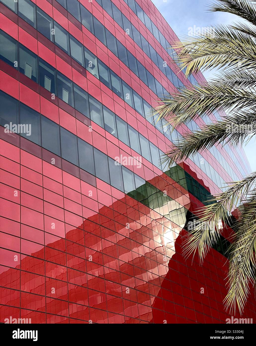 Large red building with shadows and reflections Stock Photo - Alamy