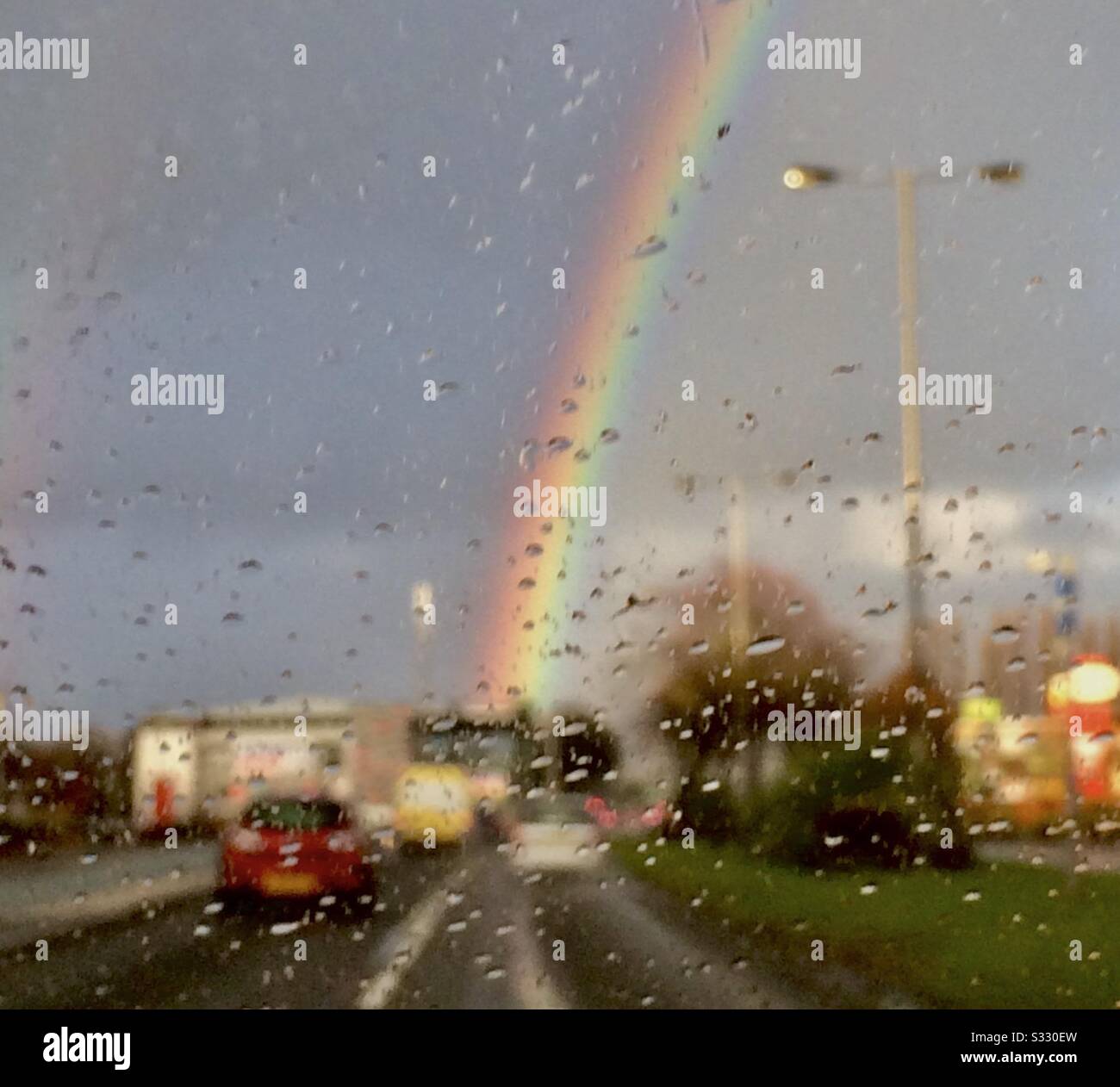 Great rainbow . View through car window Stock Photo - Alamy