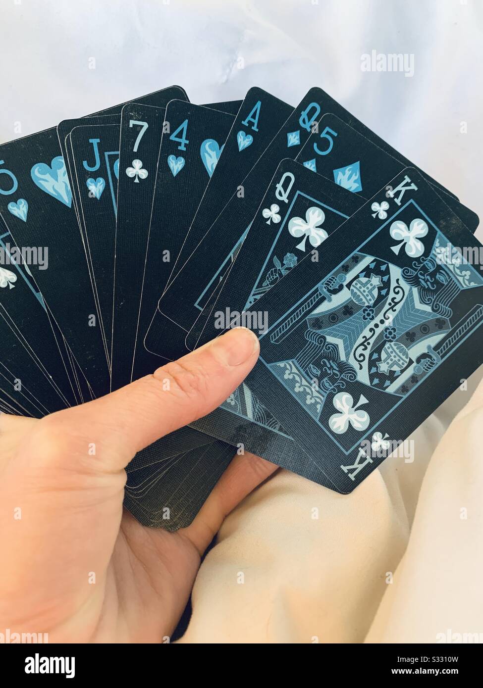 A woman holding a stack of face cards - playing cards Stock Photo - Alamy