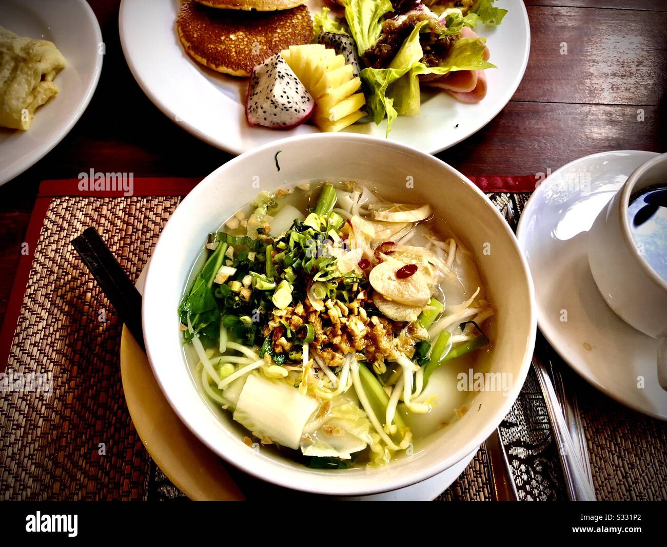 Cambodian breakfast: noodles fruits, pancakes, omelette and coffee ...