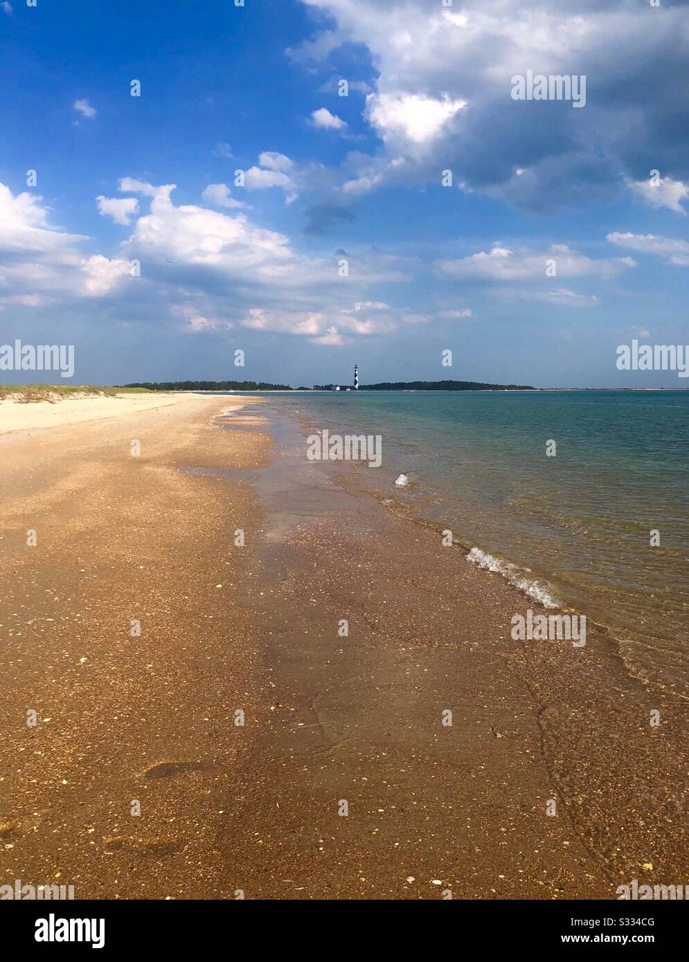 Lighthouse beach cloudy sky beach hi-res stock photography and images ...