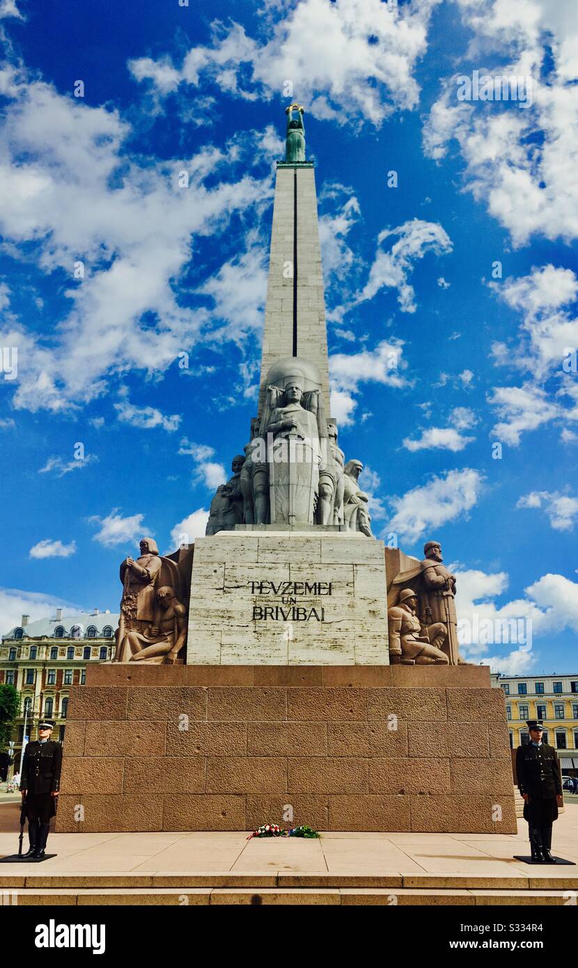 Soldiers standing by the Freedom monument in Riga, Latvia Stock Photo ...