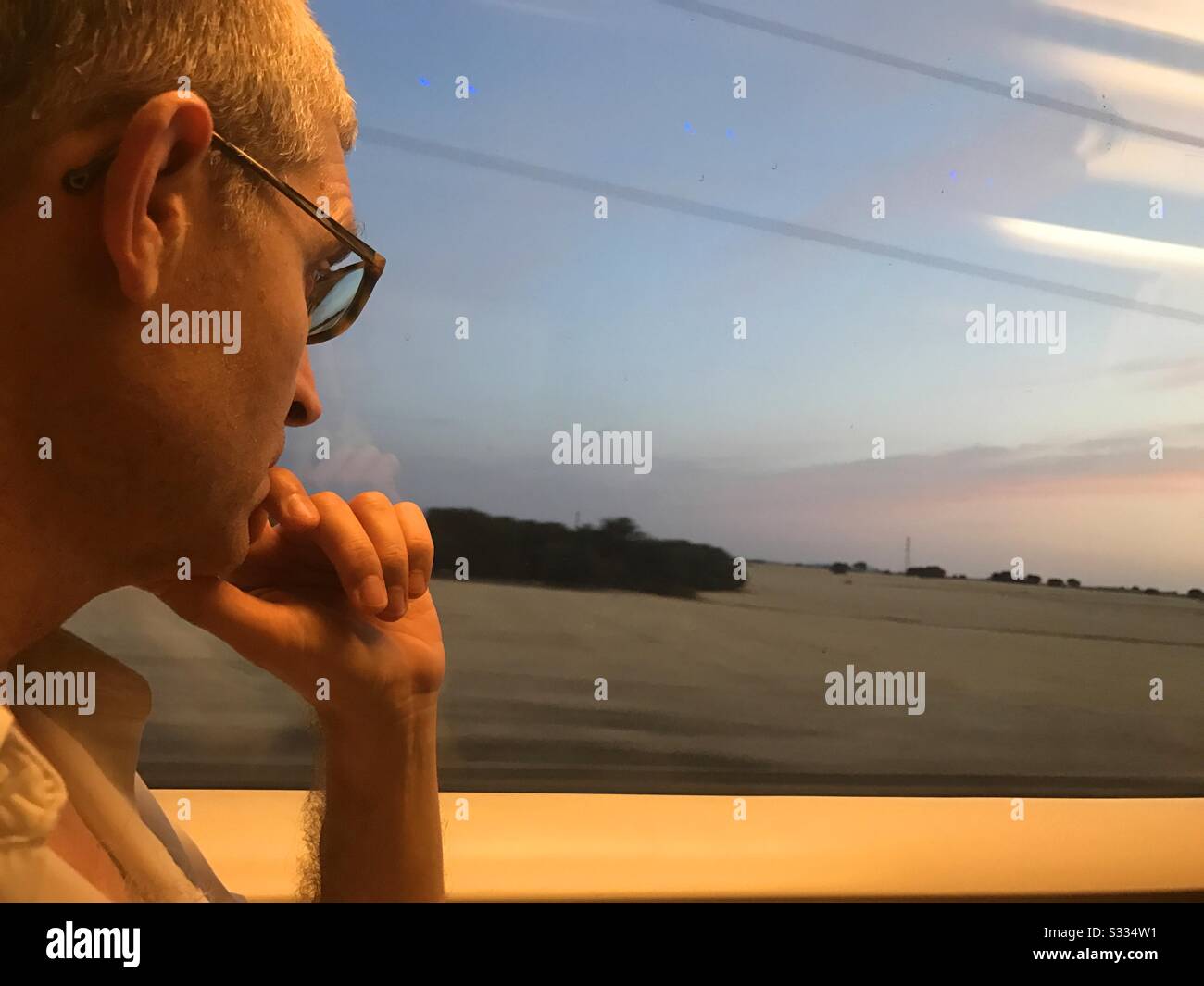 Man looking through a train window Stock Photo - Alamy