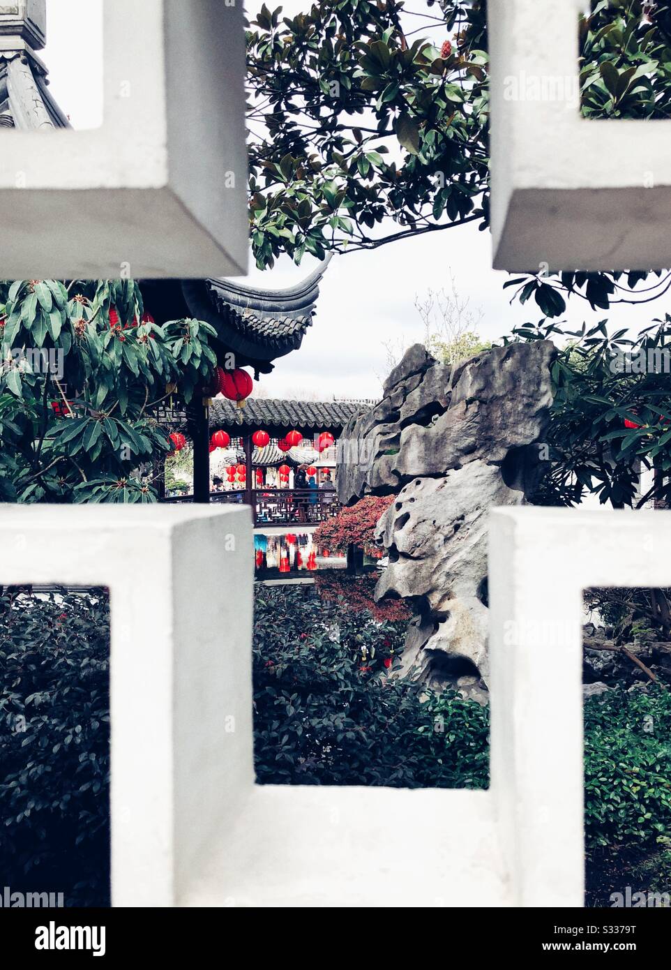Peak through ornate window into the Chinese Garden in Portland Oregon ...