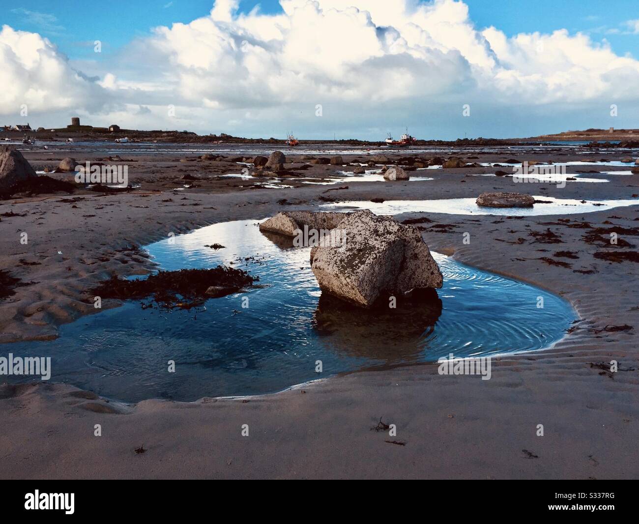 Blue rock pools on the Guernsey coast Stock Photo - Alamy