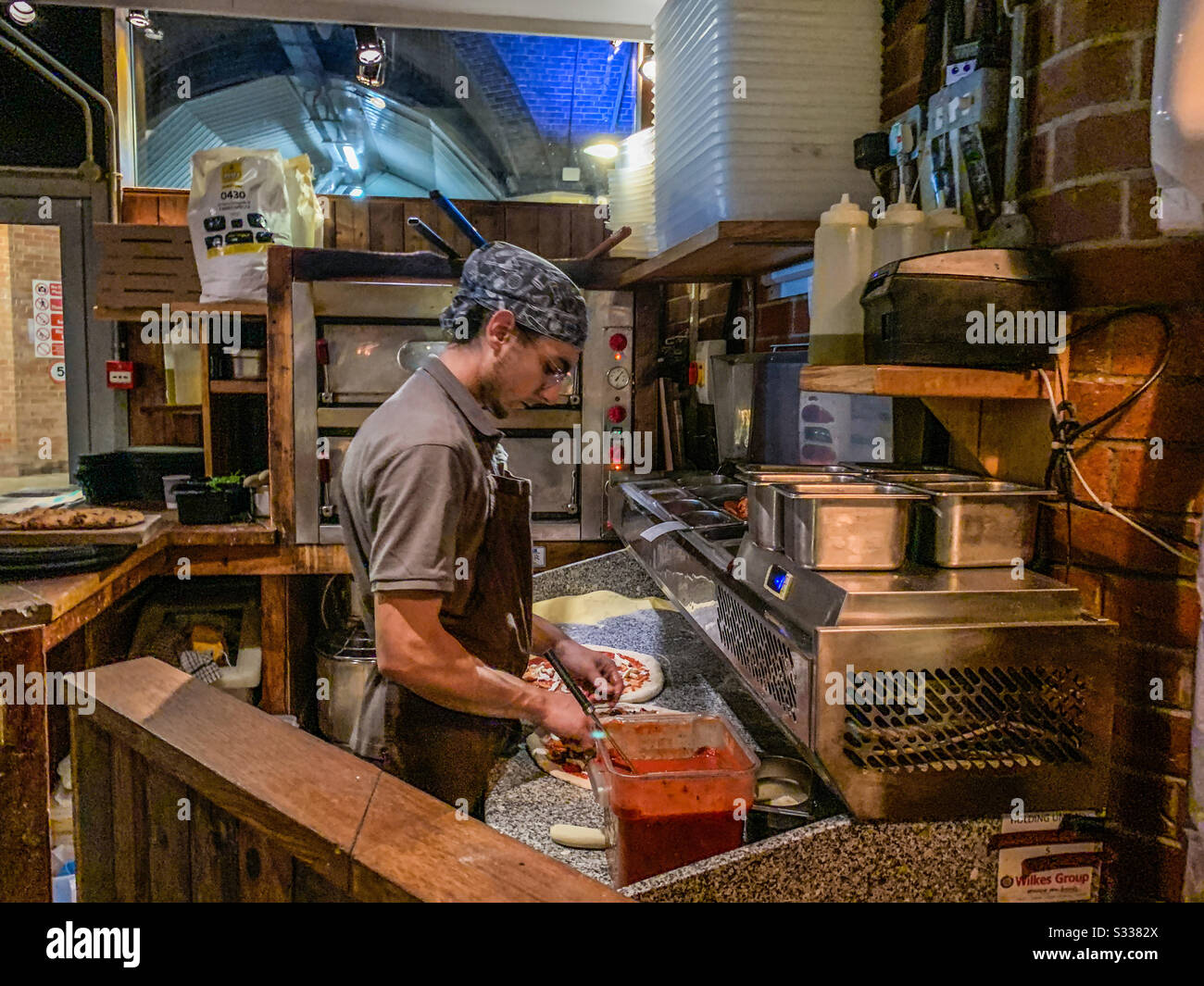 Making pizza in a restaurant Stock Photo - Alamy
