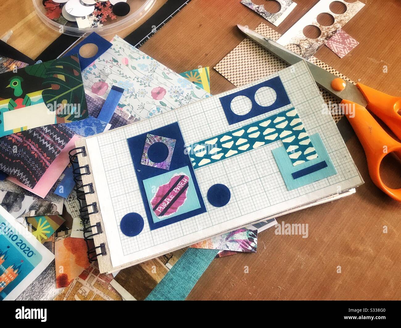 Cut paper collage created in a small journal, artist's materials in the ...