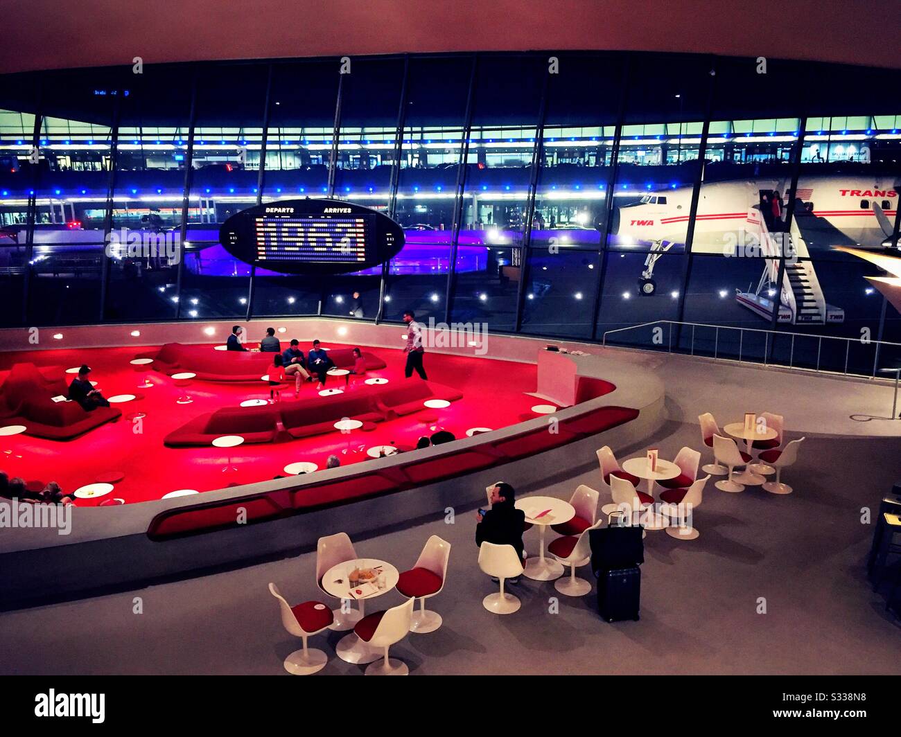 People enjoying cocktails at the sunken lounge at the heart of the TWA ...