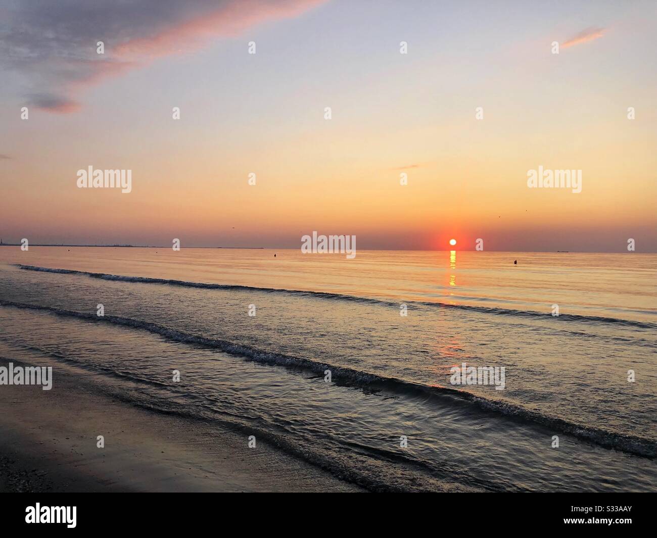 Sunrise on the beach Stock Photo - Alamy
