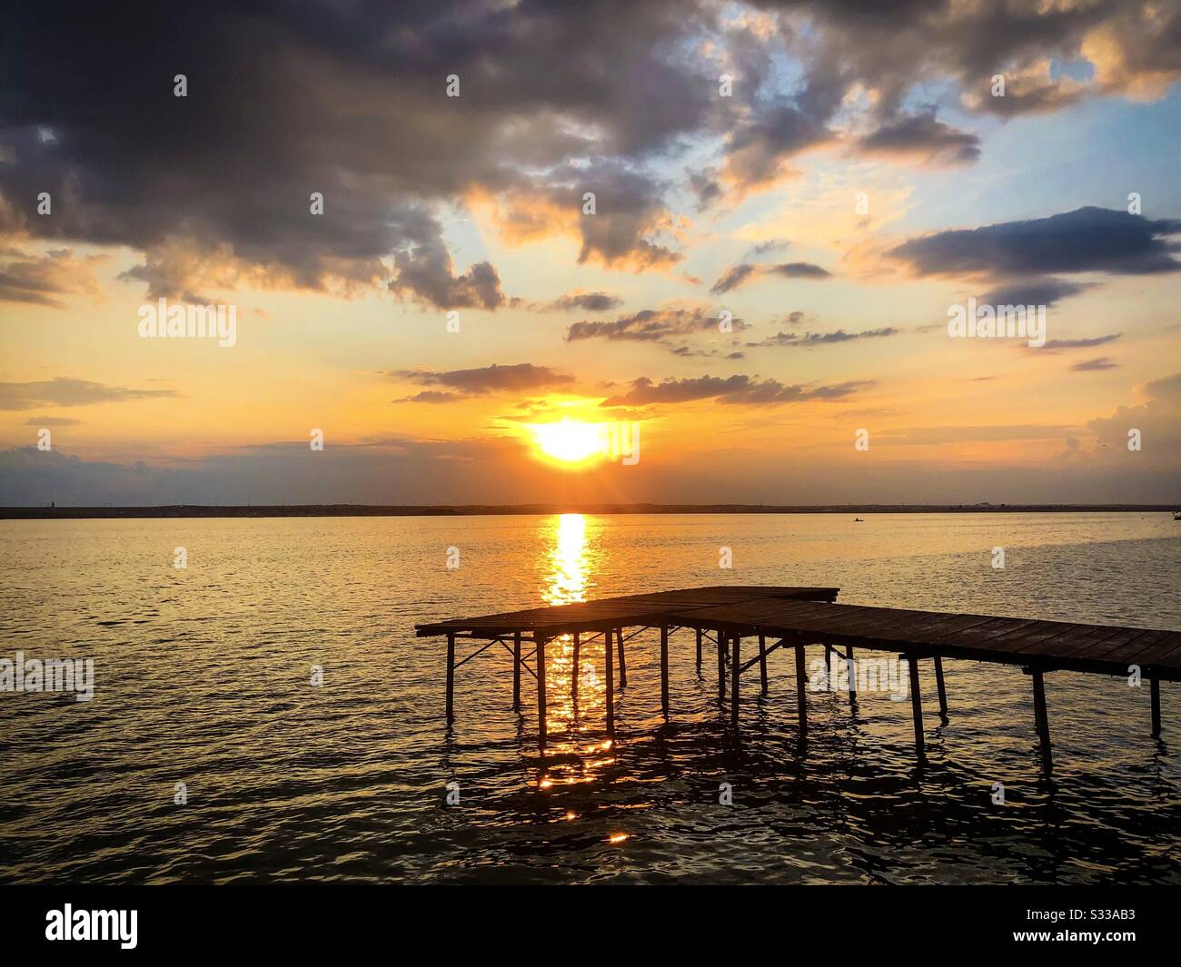 Sunset over the water Stock Photo - Alamy