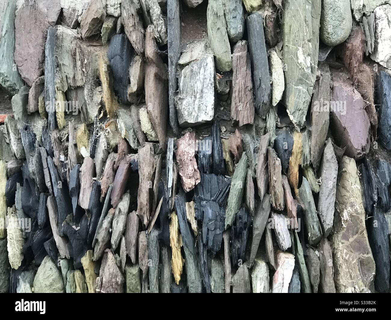 Natural stones creating a wall by tidal waters Stock Photo - Alamy