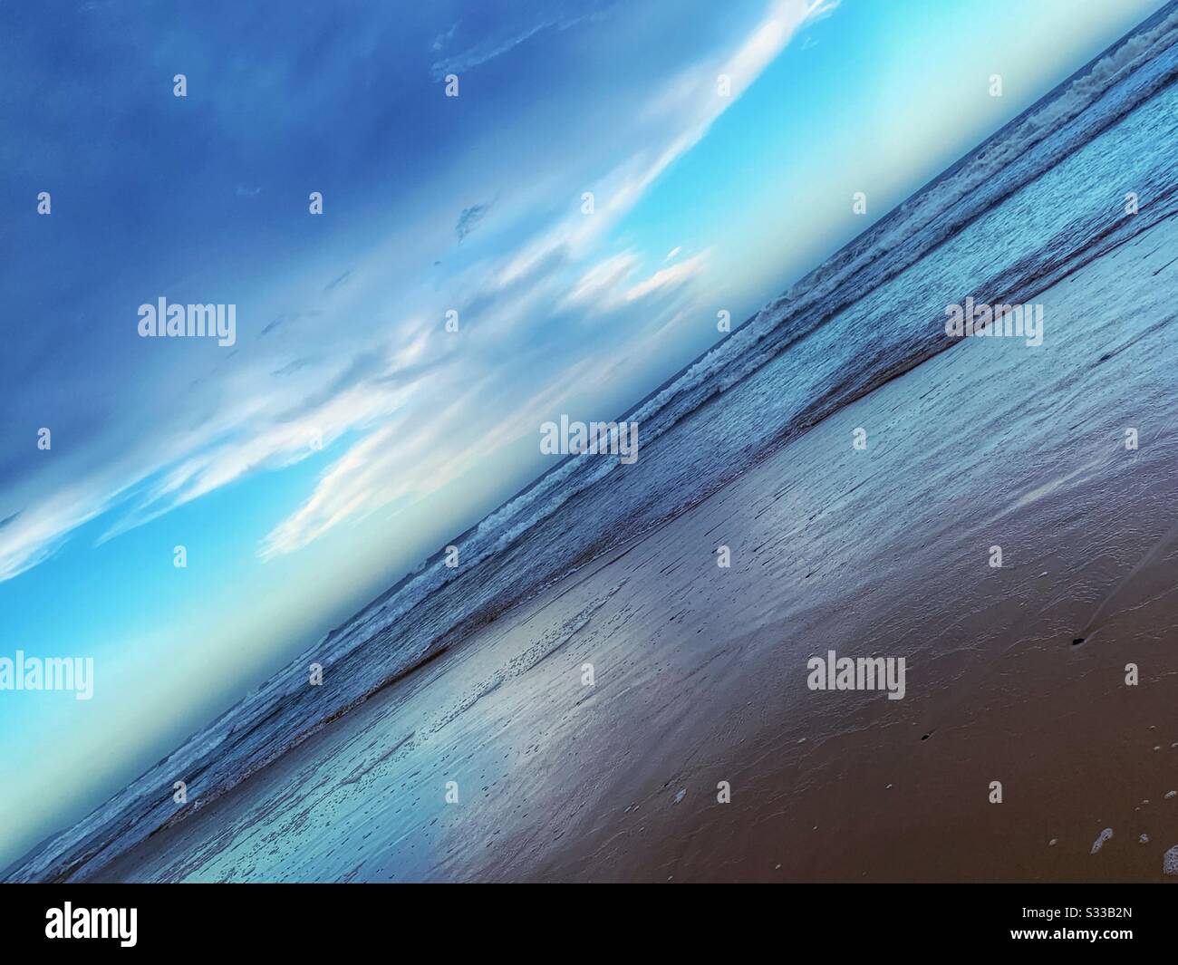 Wild colours of a beach at dusk Stock Photo - Alamy
