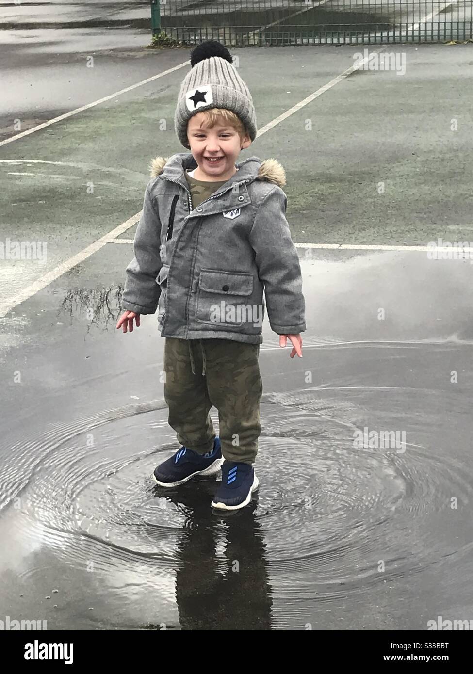 Boy jumping in puddles hi-res stock photography and images - Alamy