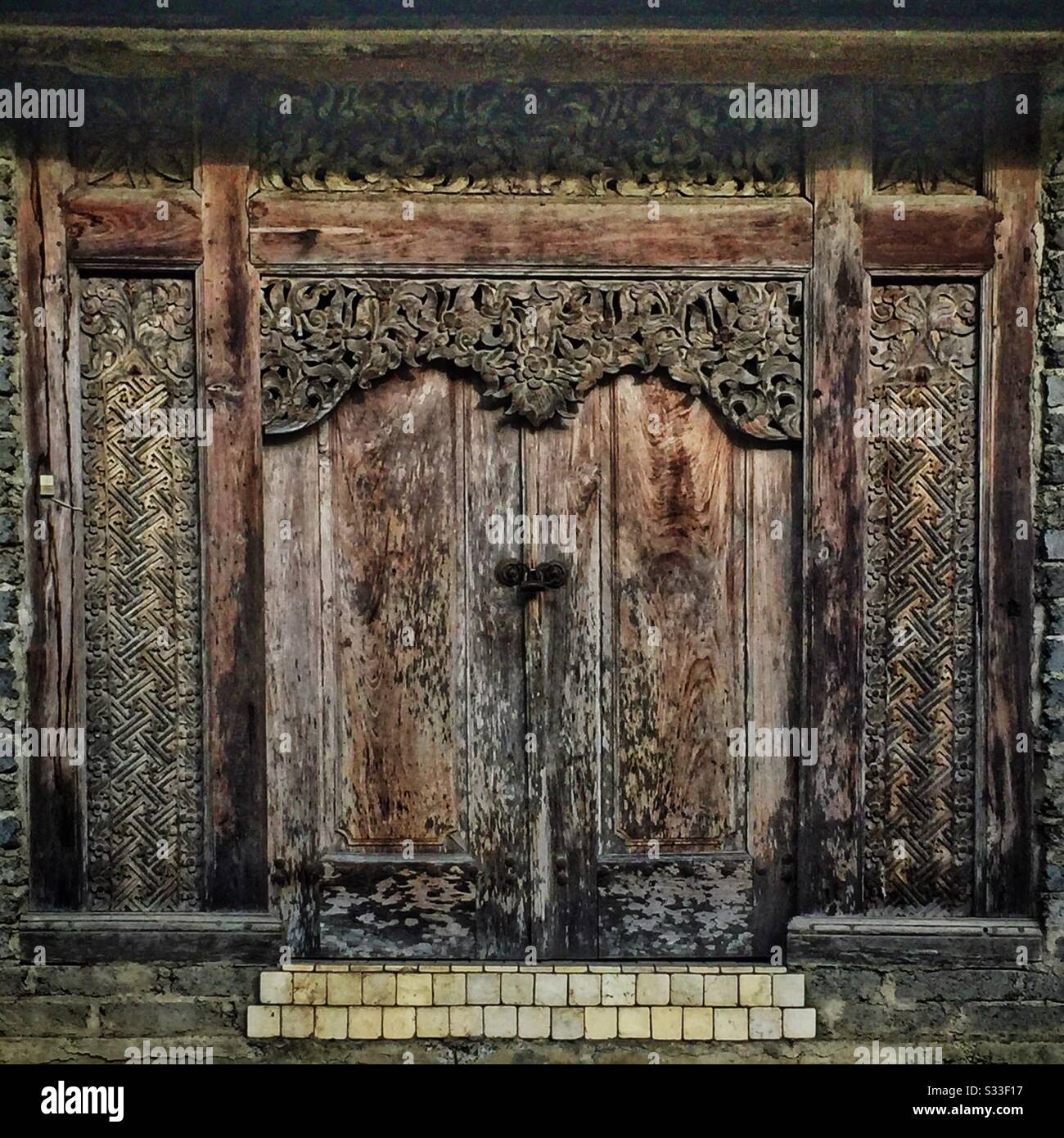 Traditional carved wooden doors, the entrance to a residential house ...
