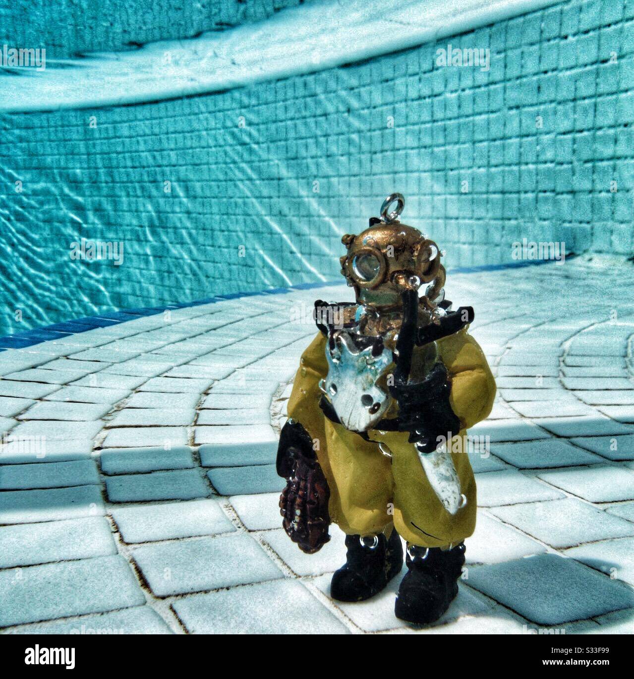 Deep sea diver toy in swimming pool Stock Photo - Alamy