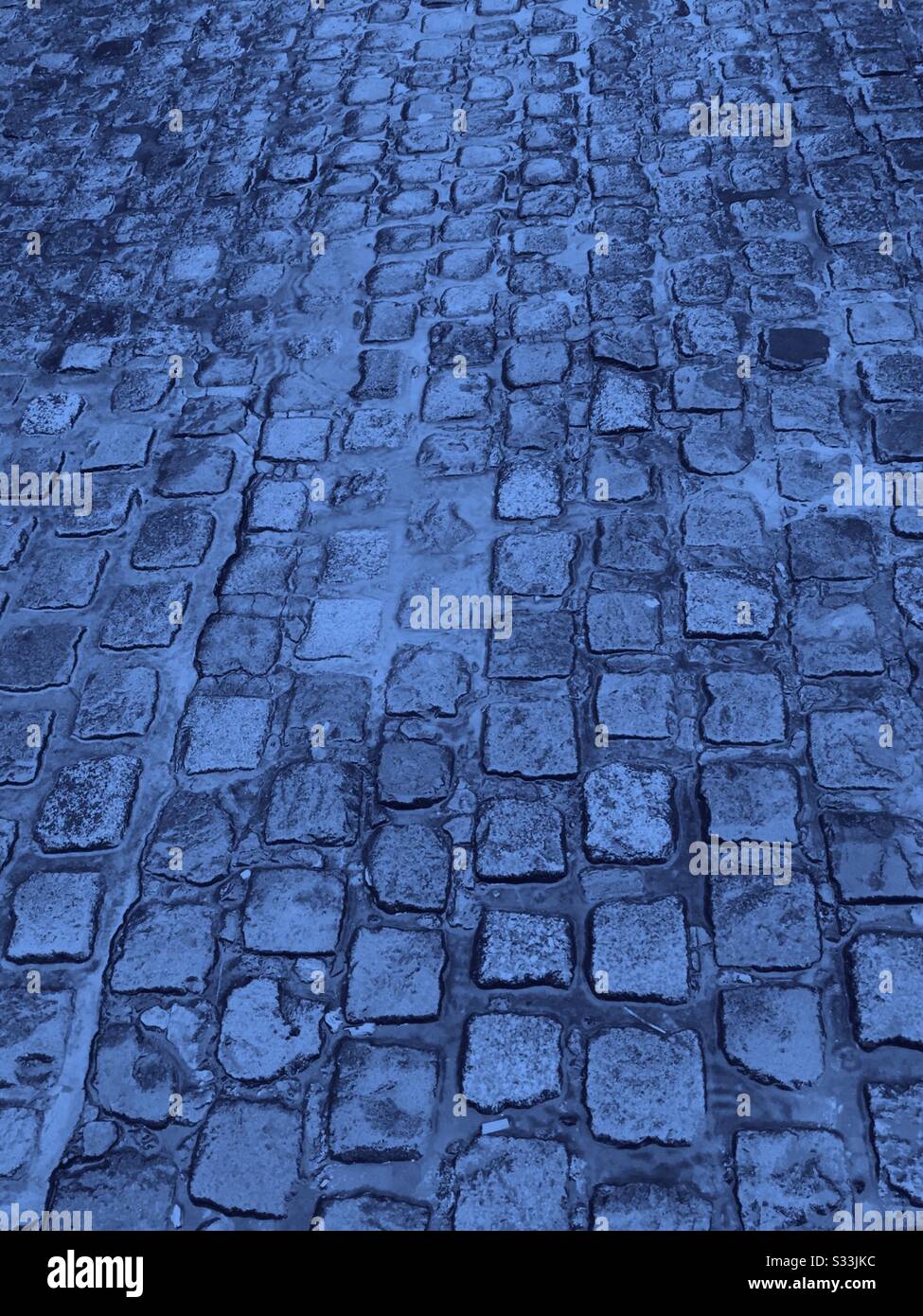 Cobblestones in Pantone Classic Blue 19-4052. Old fashioned road of ...