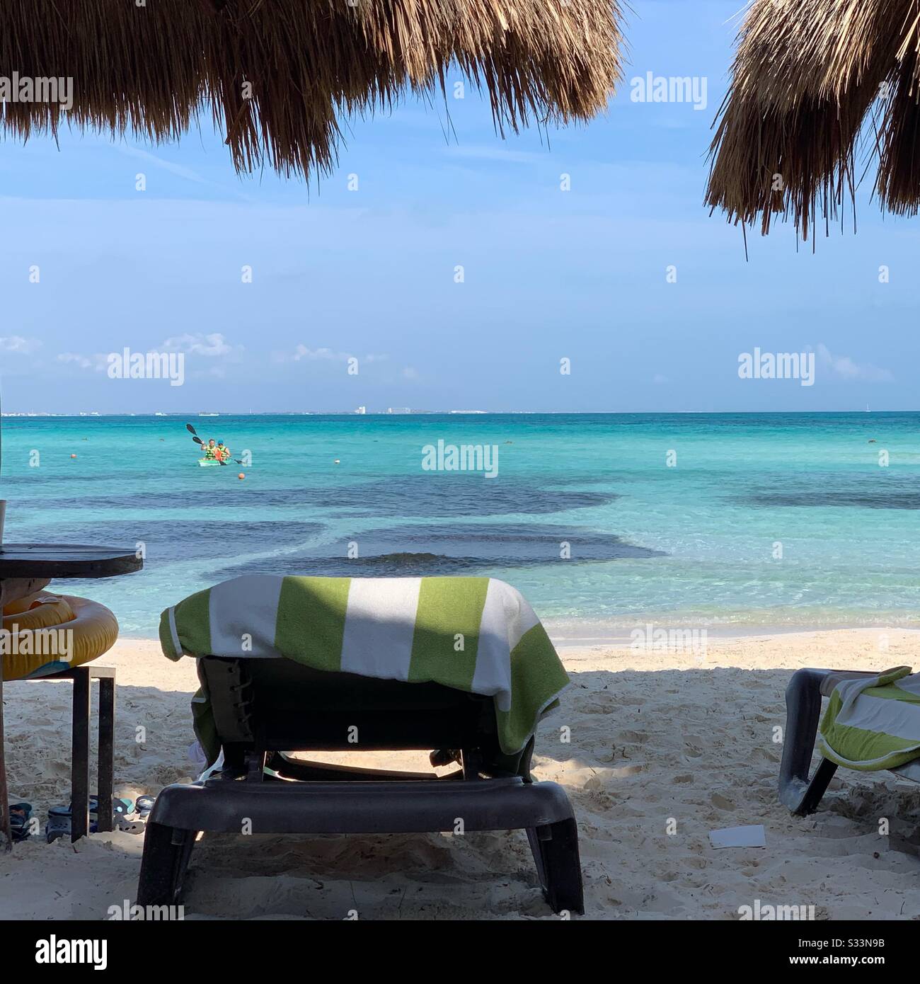 Shaded lounge chairs on the beach in front of the Hyatt Ziva Resort ...