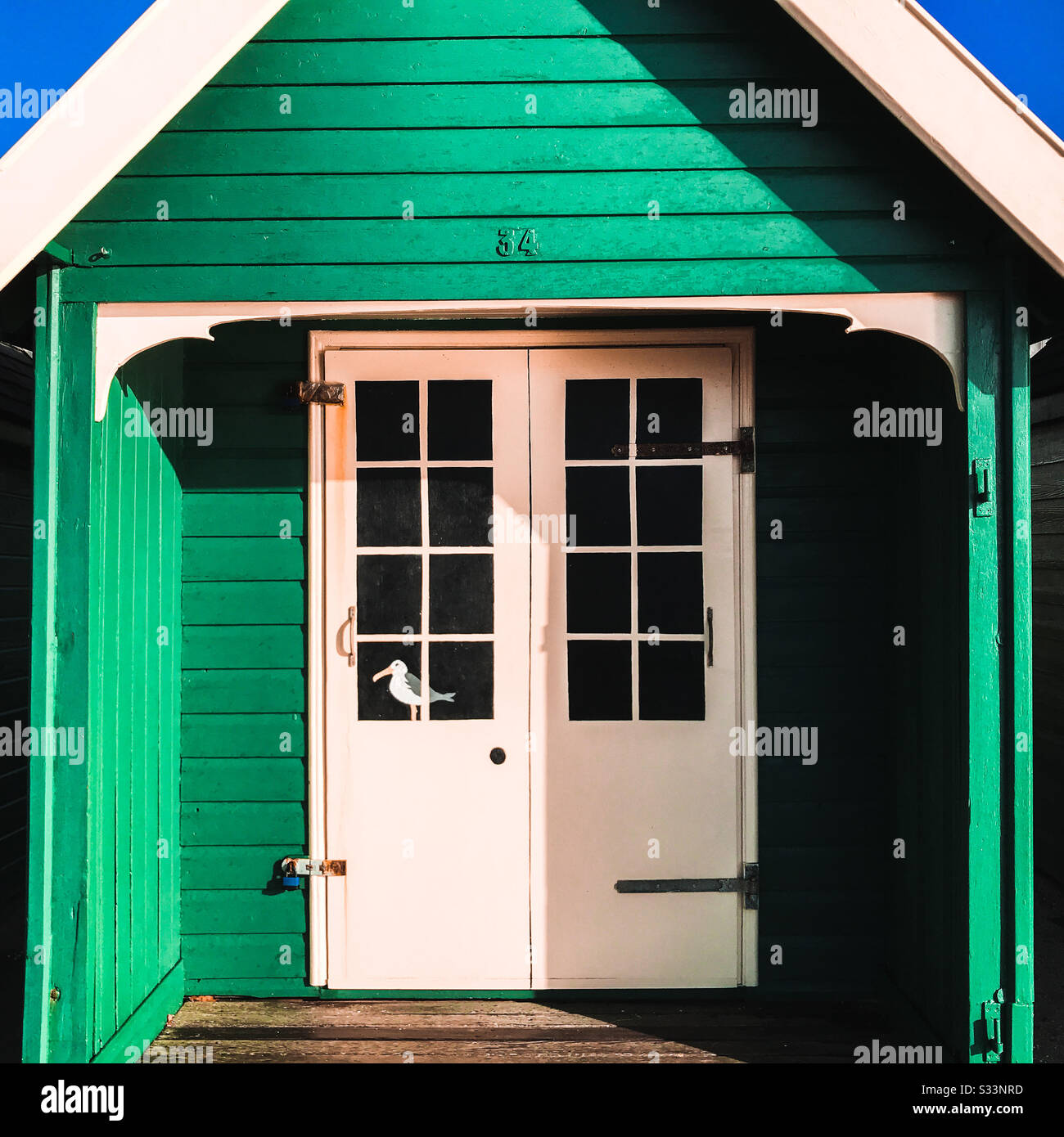 Bright green beach hut hi-res stock photography and images - Alamy