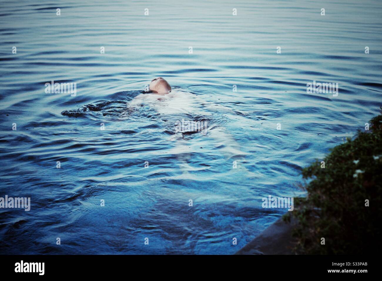 Floating at the pool Stock Photo - Alamy