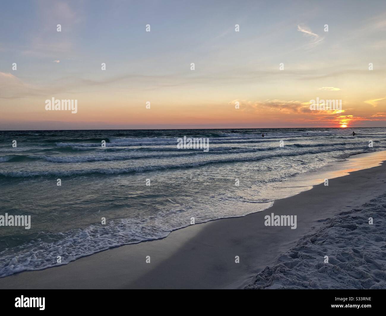 Golden sunset skies over Gulf of Mexico water with sun dipping below ...