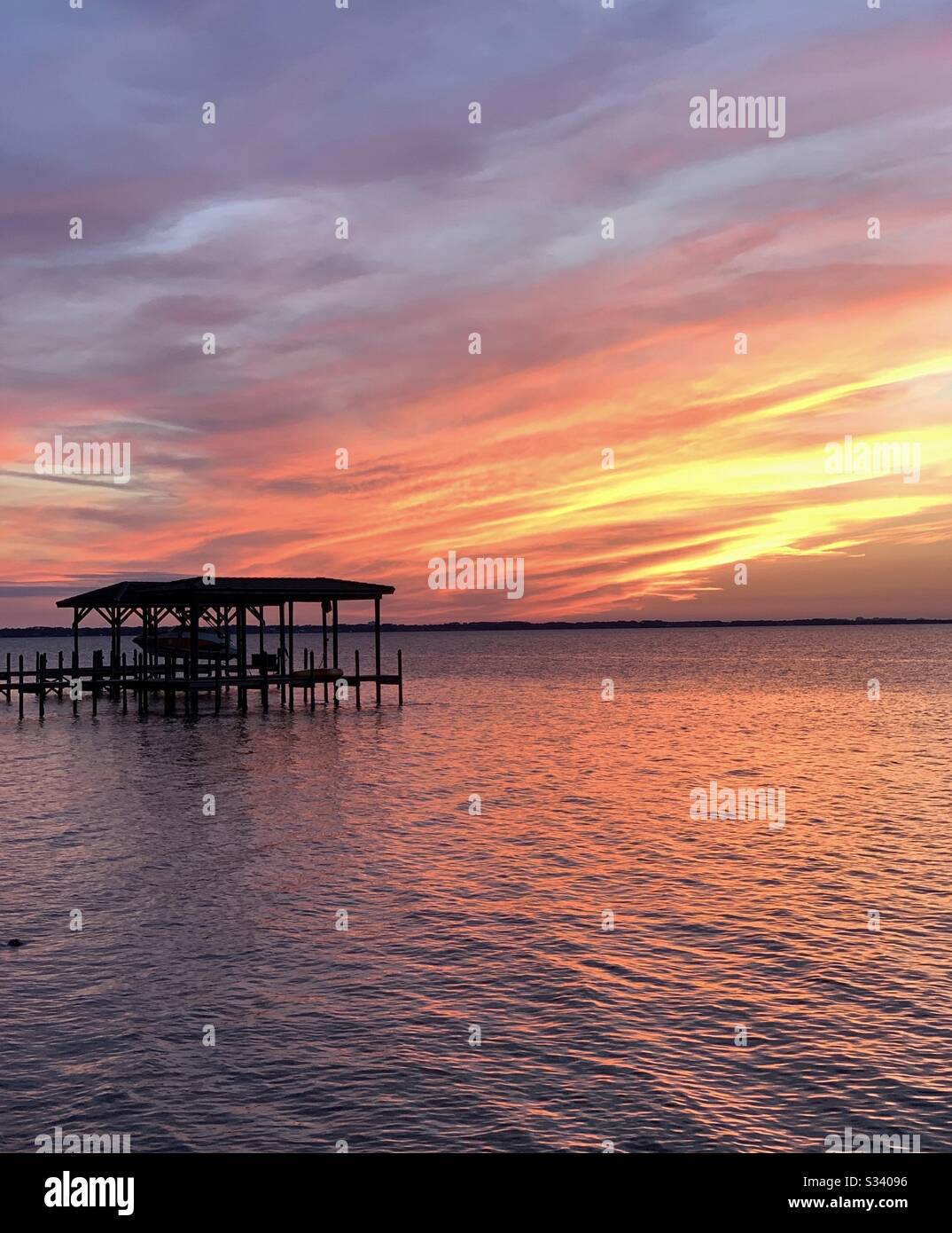 Bright and colorful sunset skies with reflections over the ...