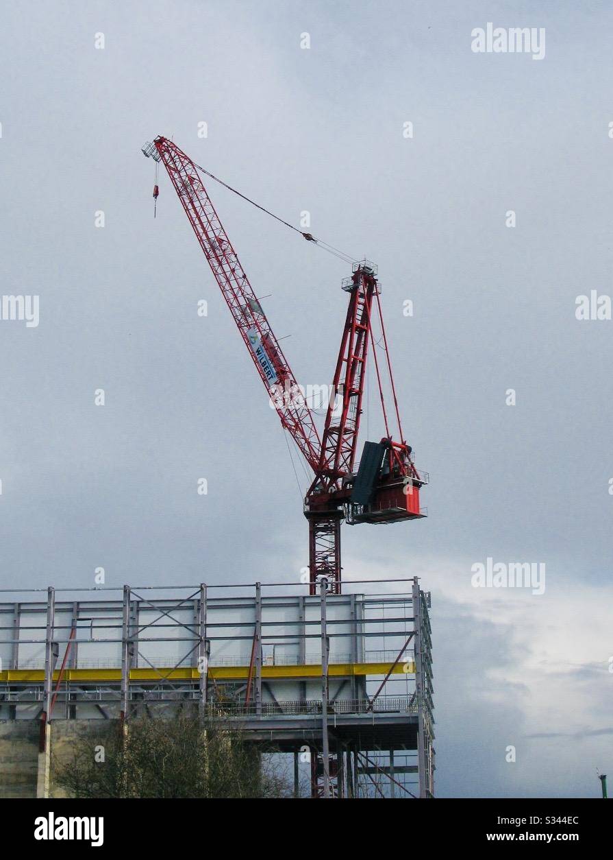 Red crane over construction site Stock Photo - Alamy
