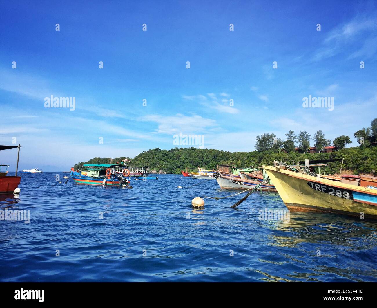 Traditional fishing boats moored in the sheltered harbour of Pulau ...
