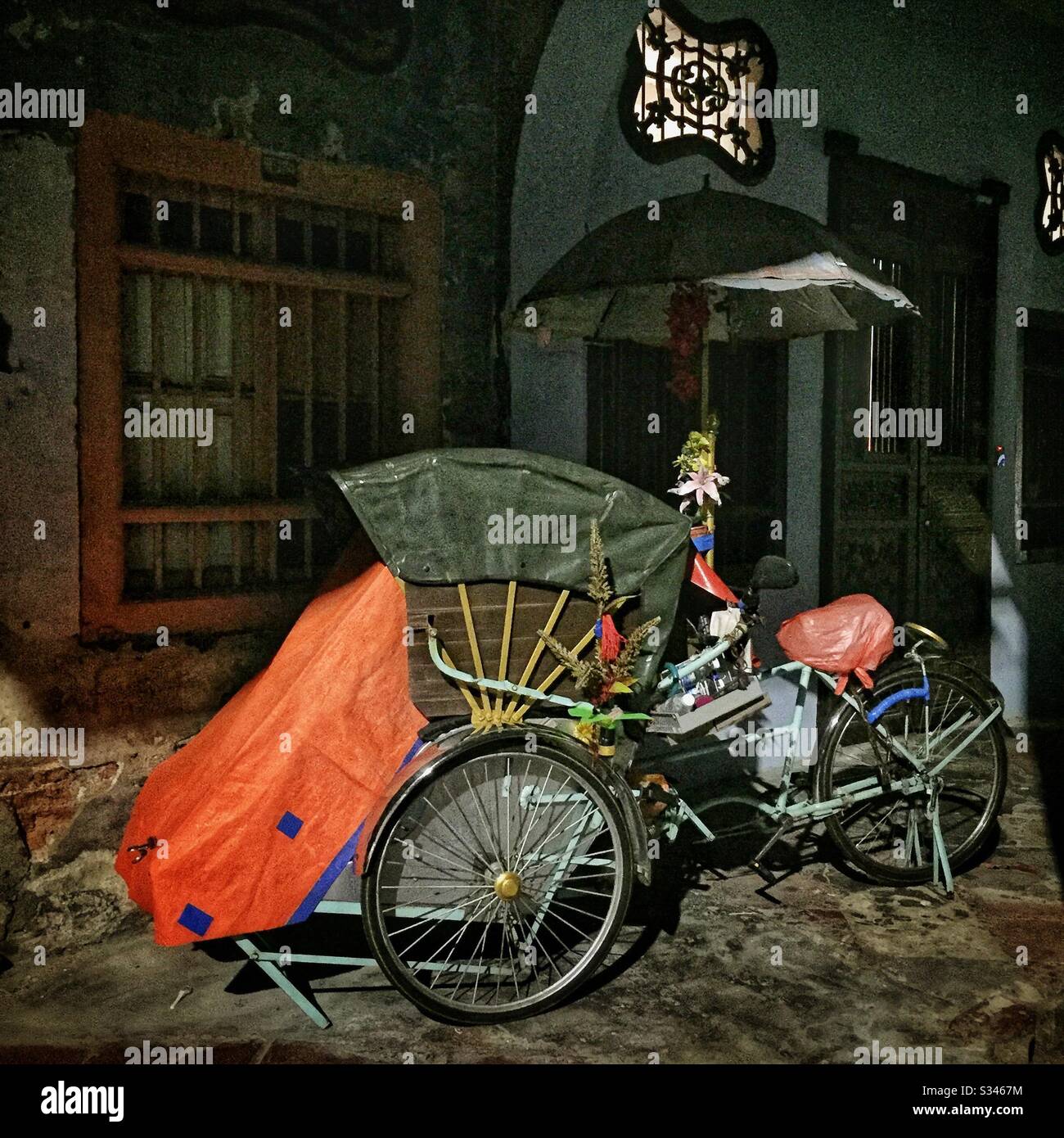 A trishaw, known locally as a 'beca', parked at night in the Old Town ...