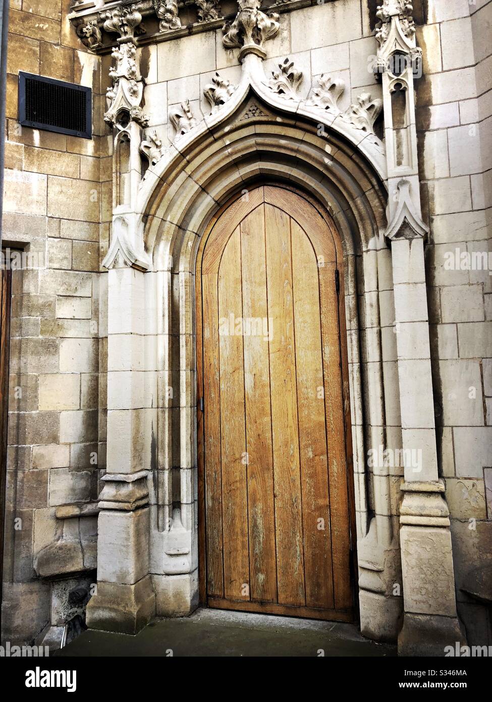 A medieval wooden doorway is seen with gothic stonework at the Palace ...