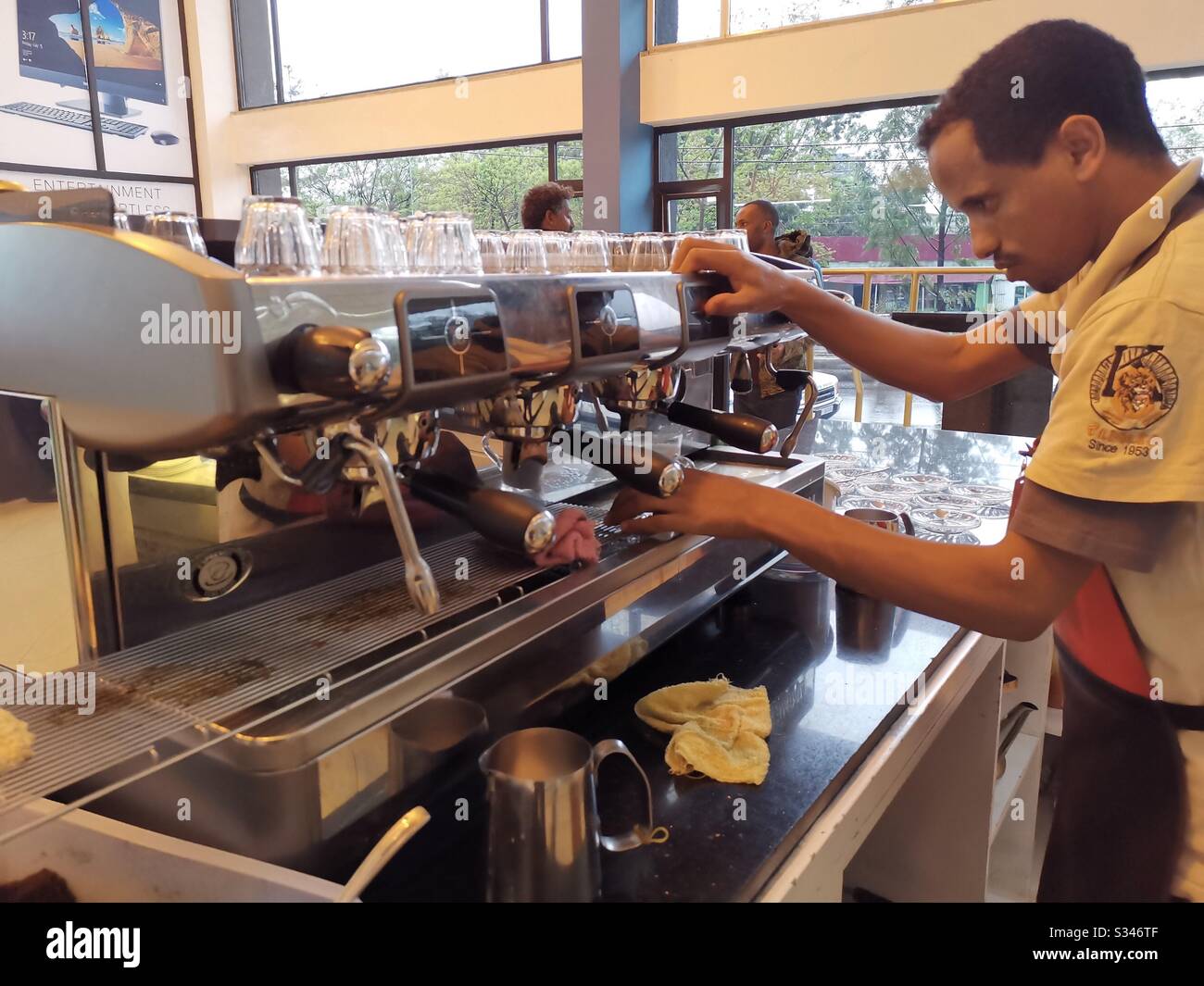 A barista preparing macchiato in Tomocca coffee shop in Addis Ababa ...