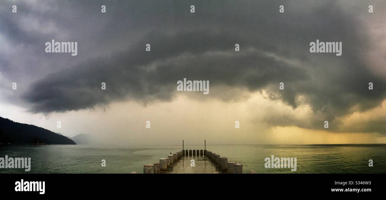 A morning rain squall over the ocean at Batu Ferringhi, Penang ...