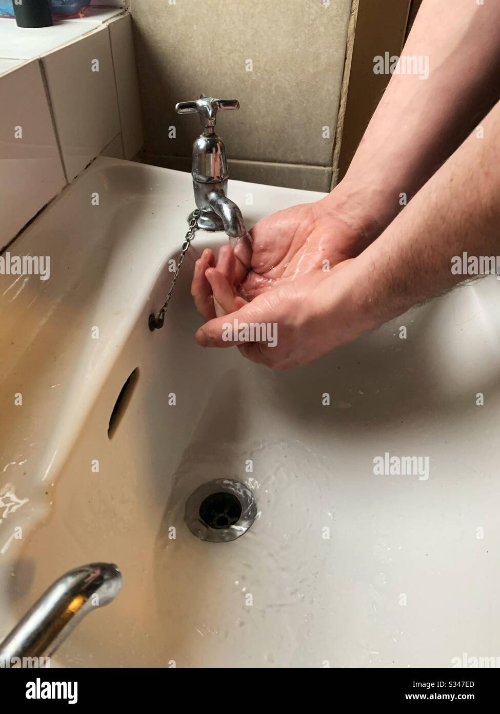Male hands being washed in sink Stock Photo - Alamy
