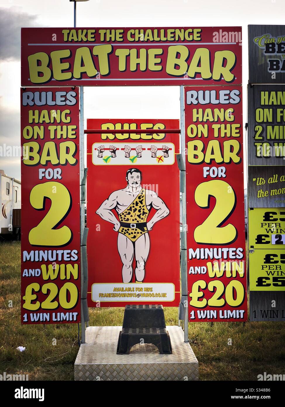 Retro beat the bar game at a travelling fairground Stock Photo - Alamy