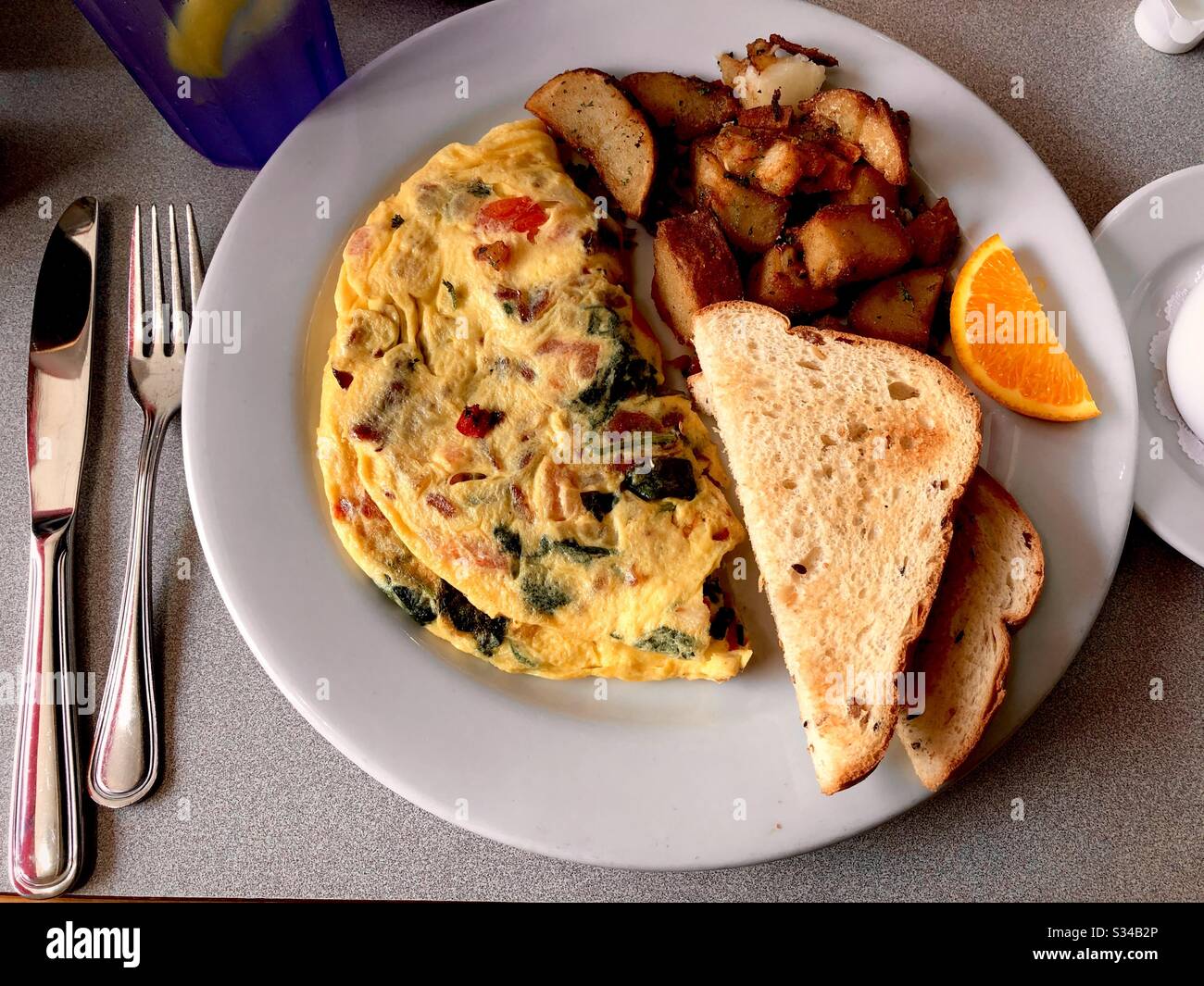 Breakfast consisting of a farmers vegetable omelette, fried potatoes ...