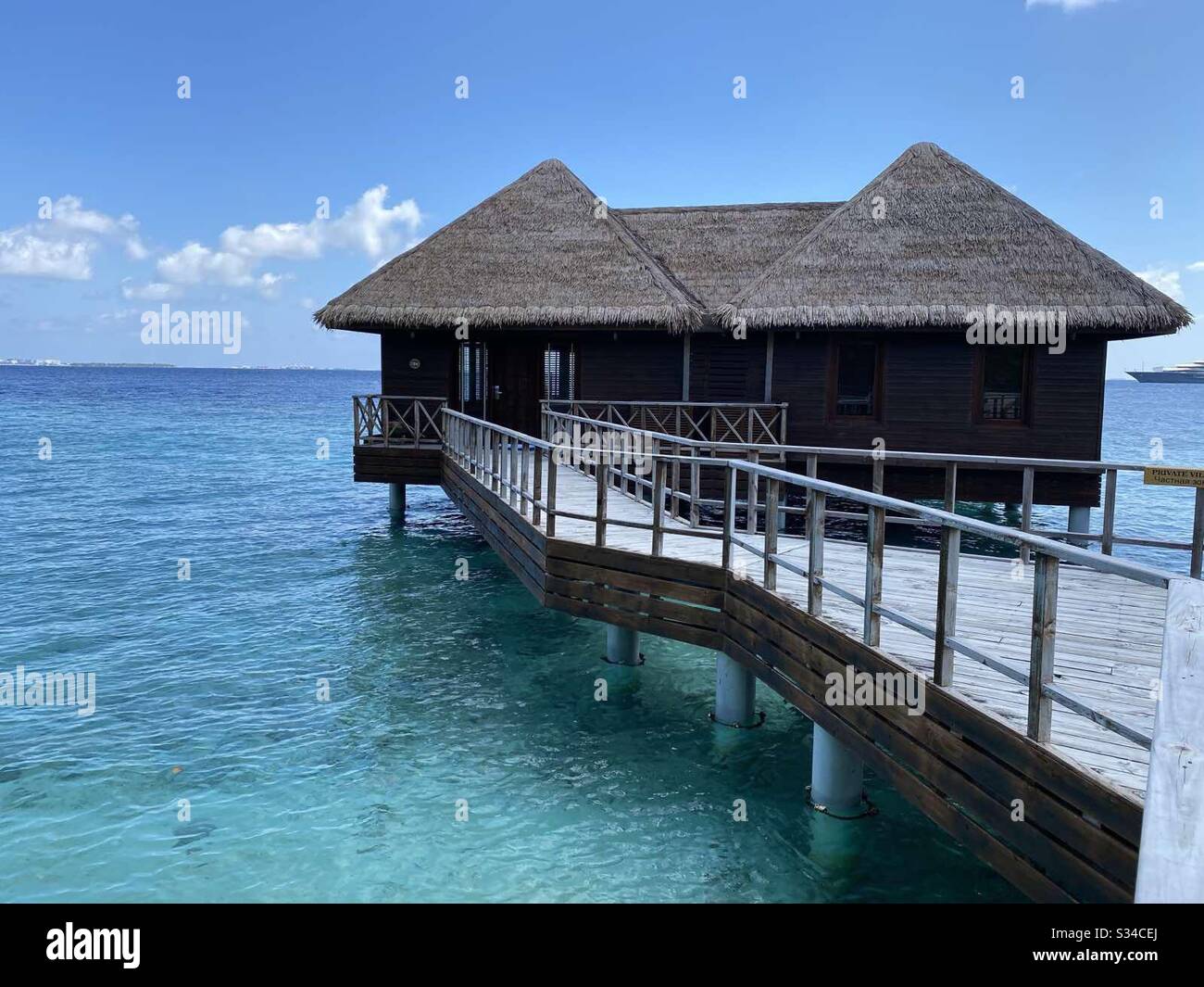Thatched roof bungalow or cabin in tropical lagoon in the Maldives ...
