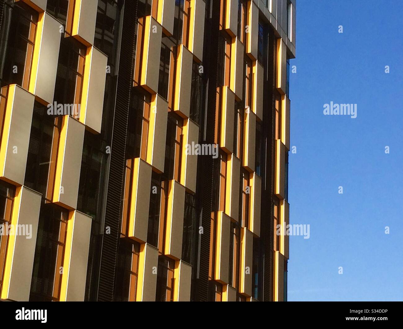 Yellow cladding against blue sky Stock Photo - Alamy