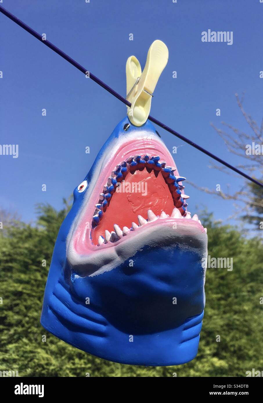 Rubber hand puppet hanging on a washing line Stock Photo - Alamy