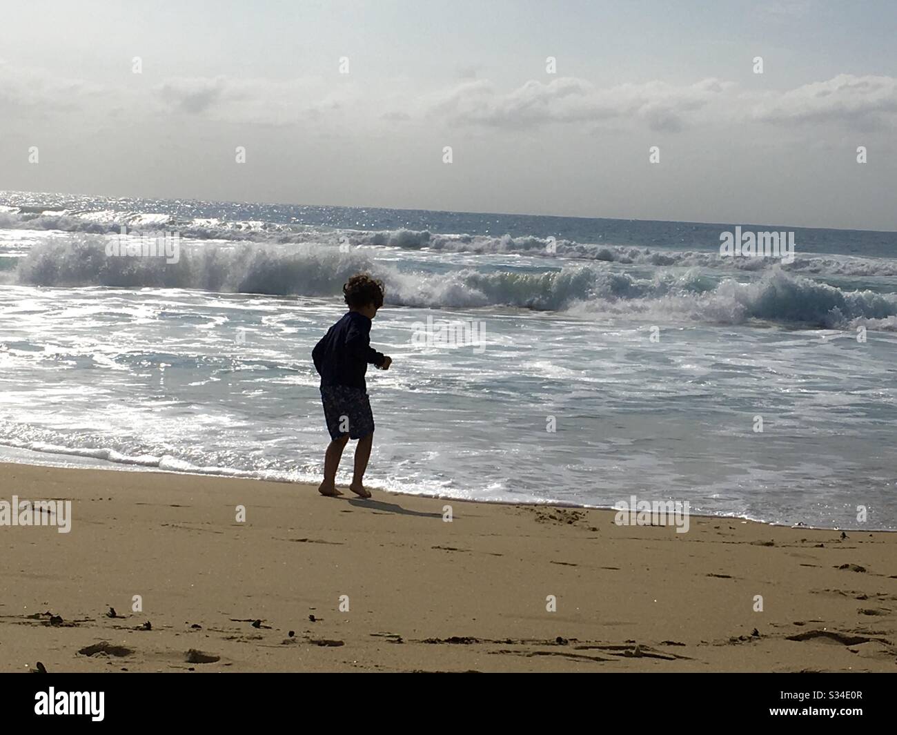 Boy at beach sunset hi-res stock photography and images - Alamy