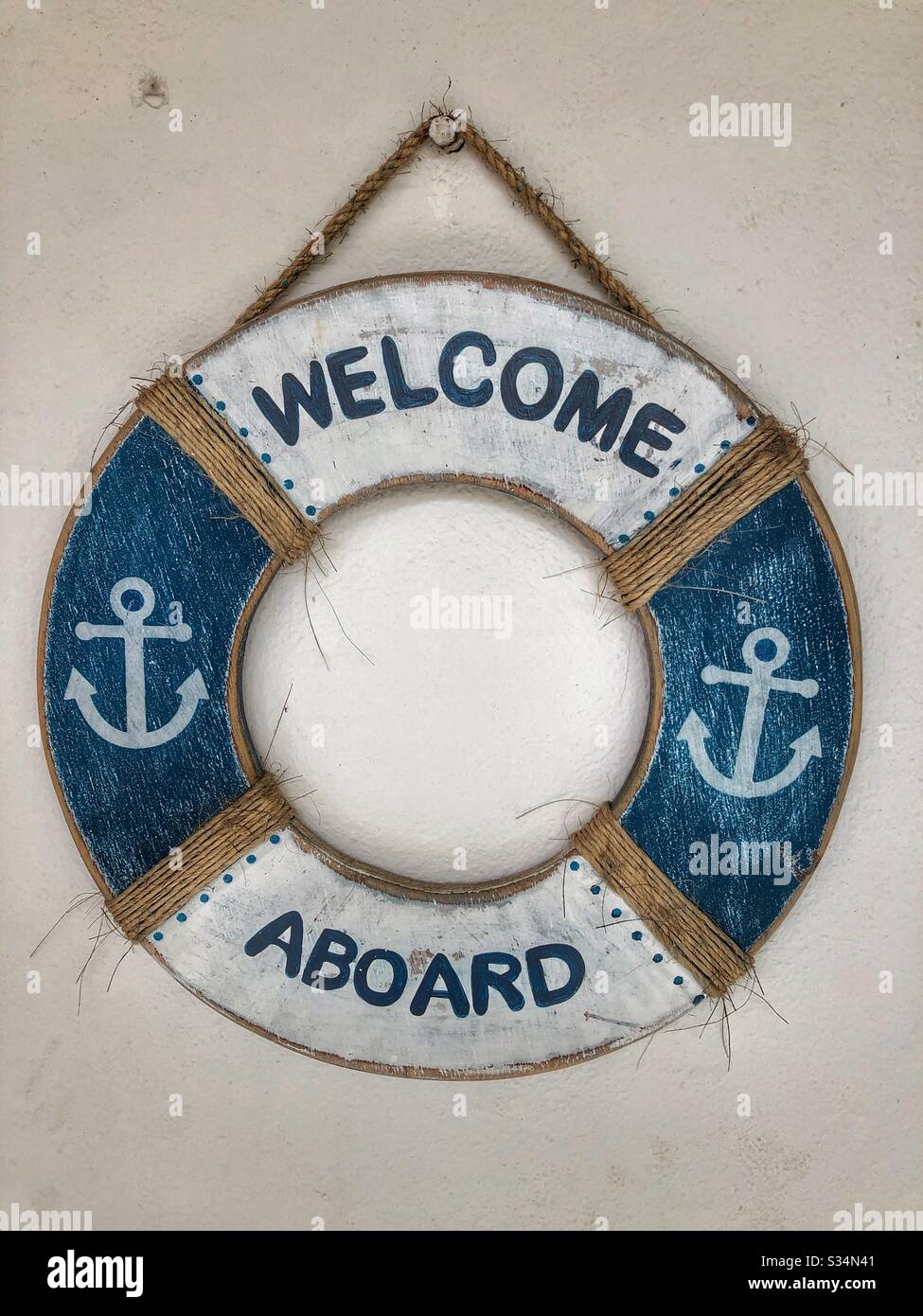 A wooden welcome sign with a nautical theme Stock Photo - Alamy
