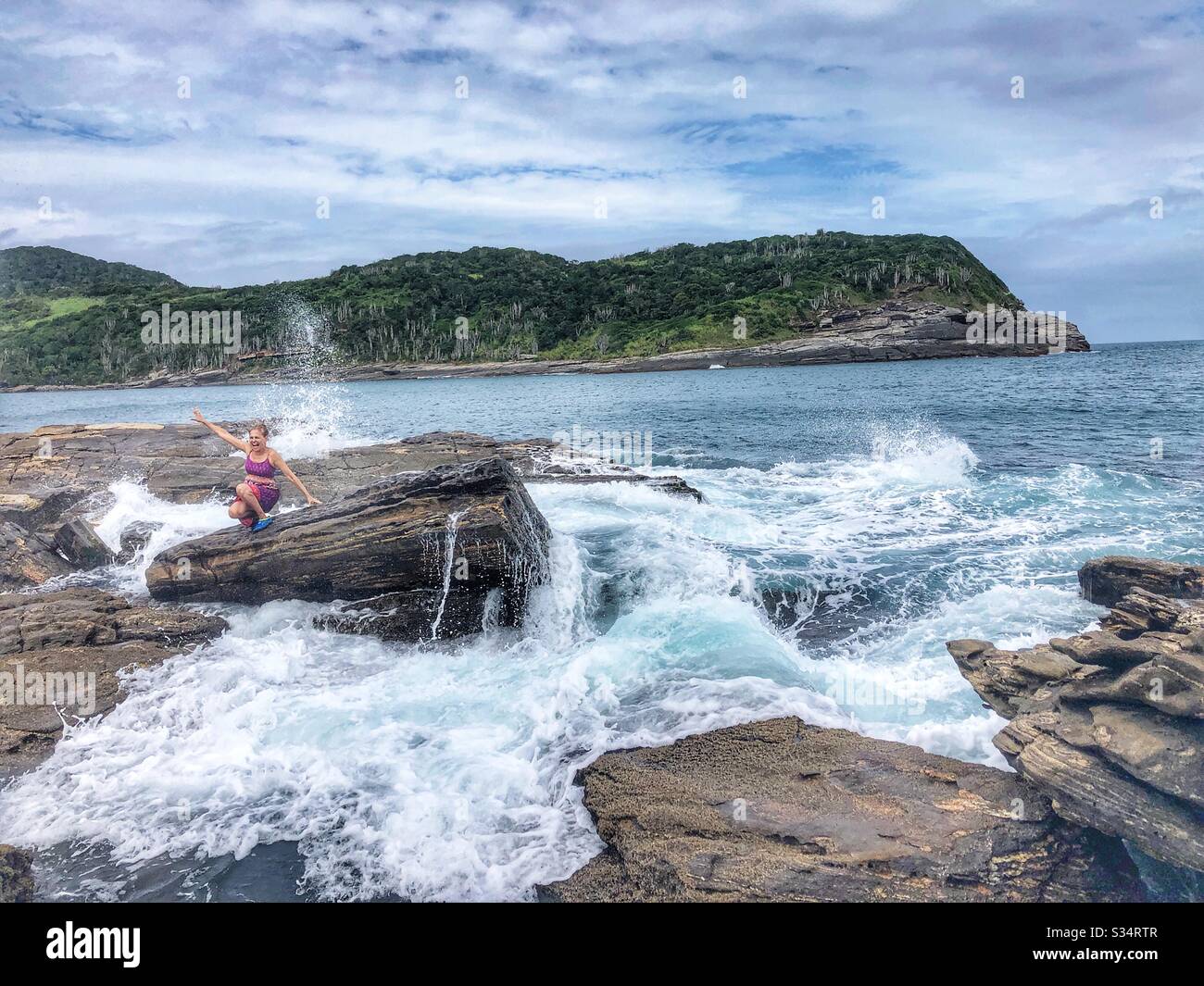Woman getting wet from splashing water Stock Photo - Alamy