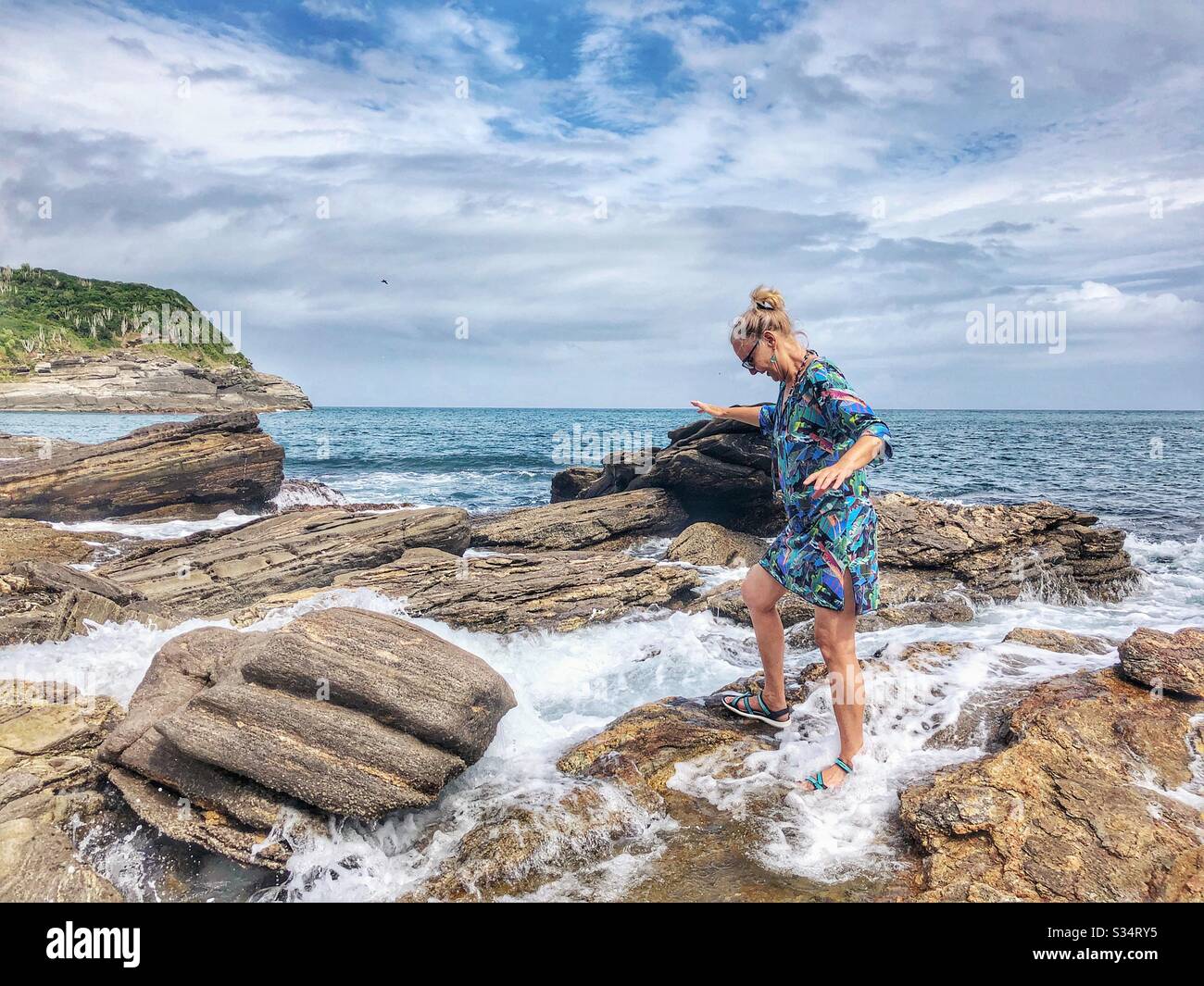 Woman walking on rocks hi-res stock photography and images - Alamy