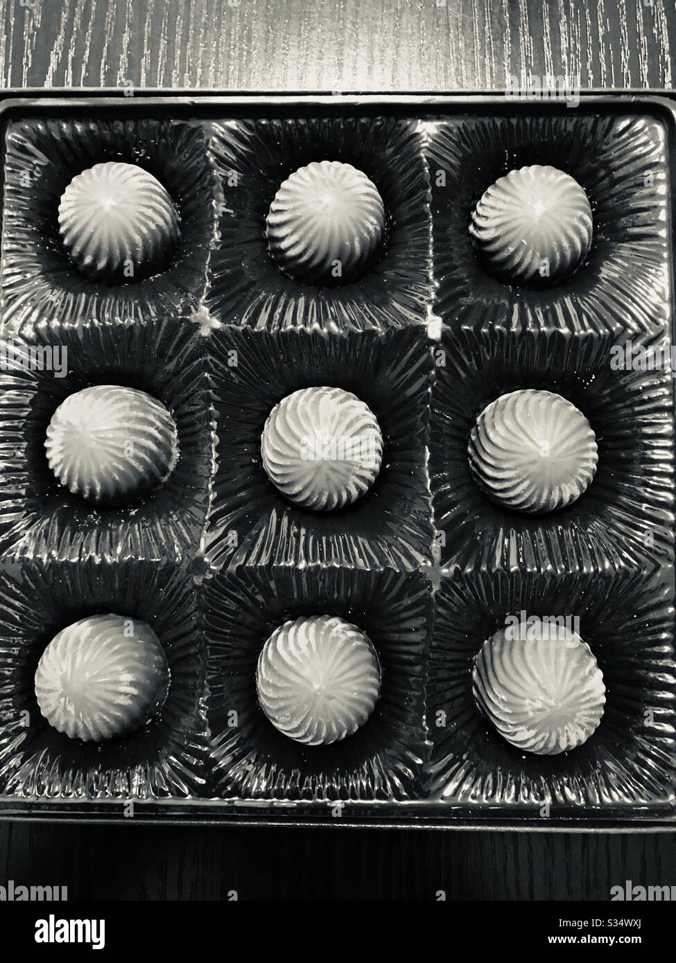 Round shape chocolate in box close-up -black & white mode Stock Photo ...