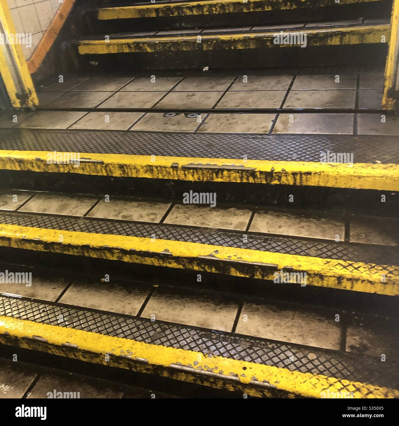 Yellow lines on London Underground steps Stock Photo - Alamy