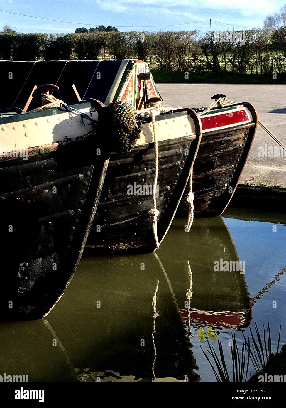 The bow of three historic narrowboats Stock Photo - Alamy