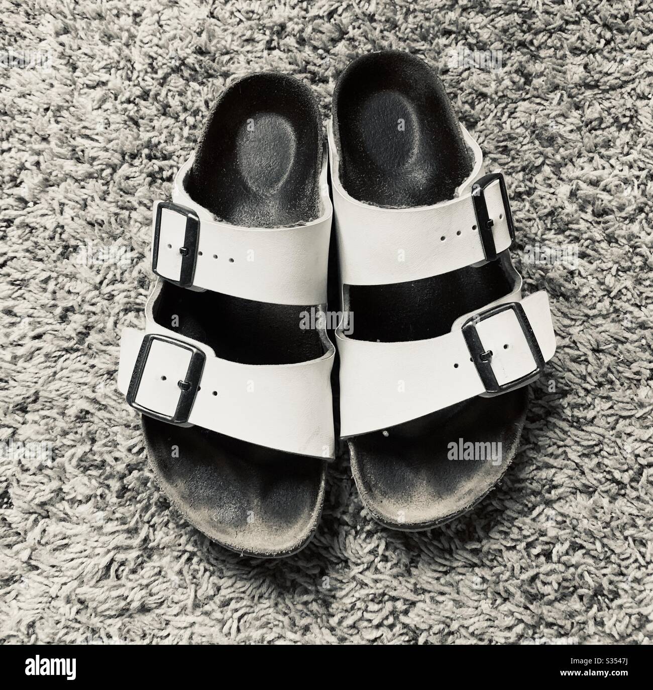 Pair of white sandals worn in the summer Stock Photo - Alamy