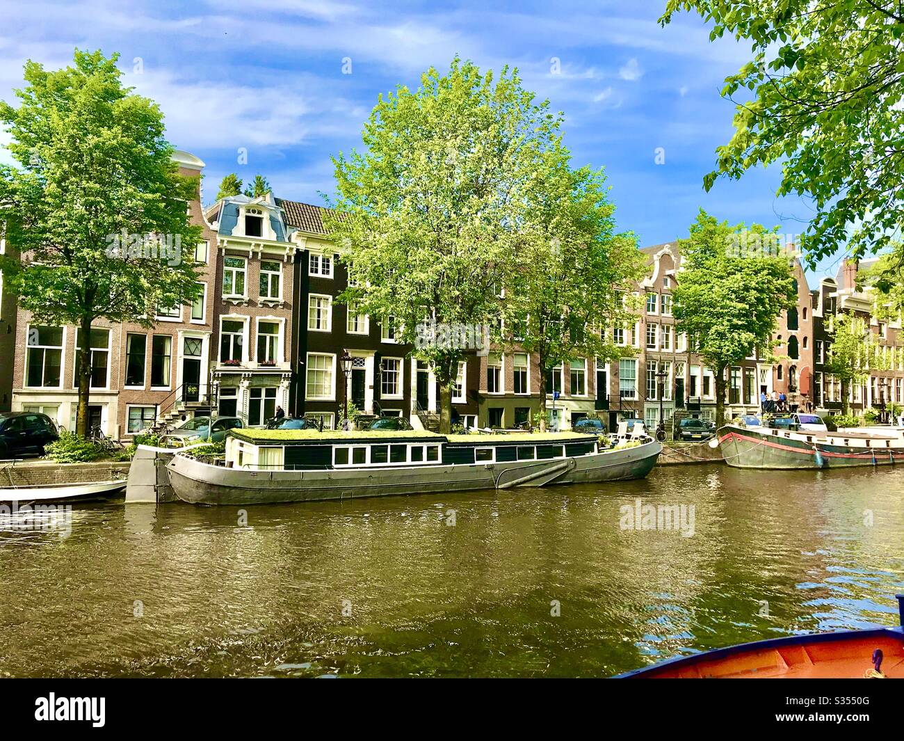 Amsterdam canal and boats Stock Photo - Alamy