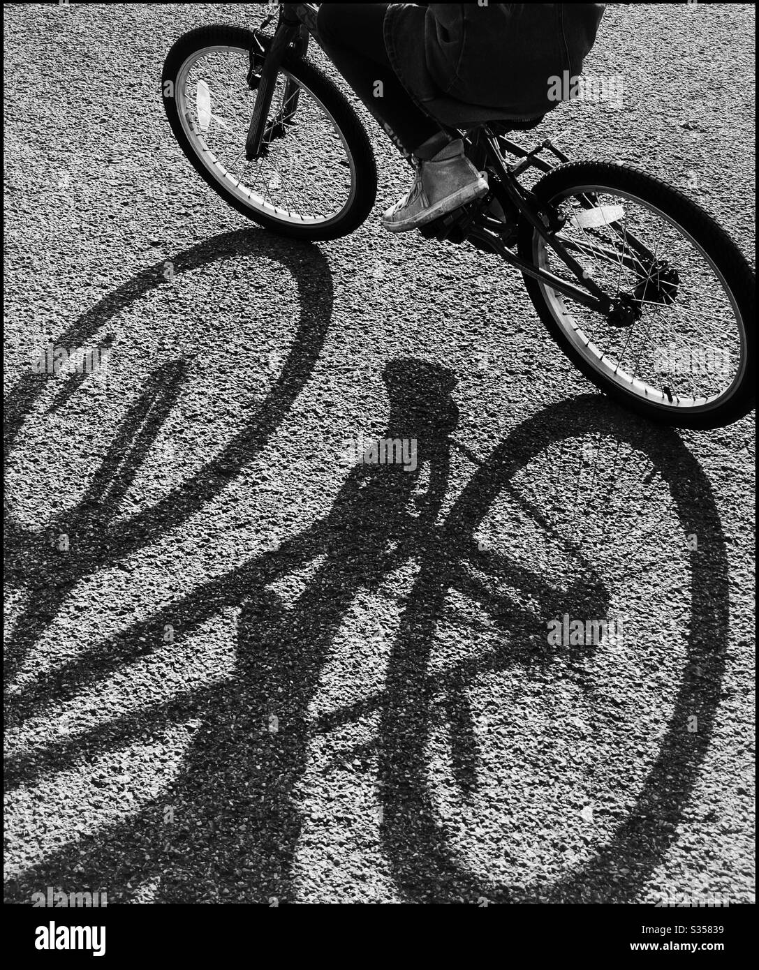 Shadow girl riding bike hi-res stock photography and images - Alamy