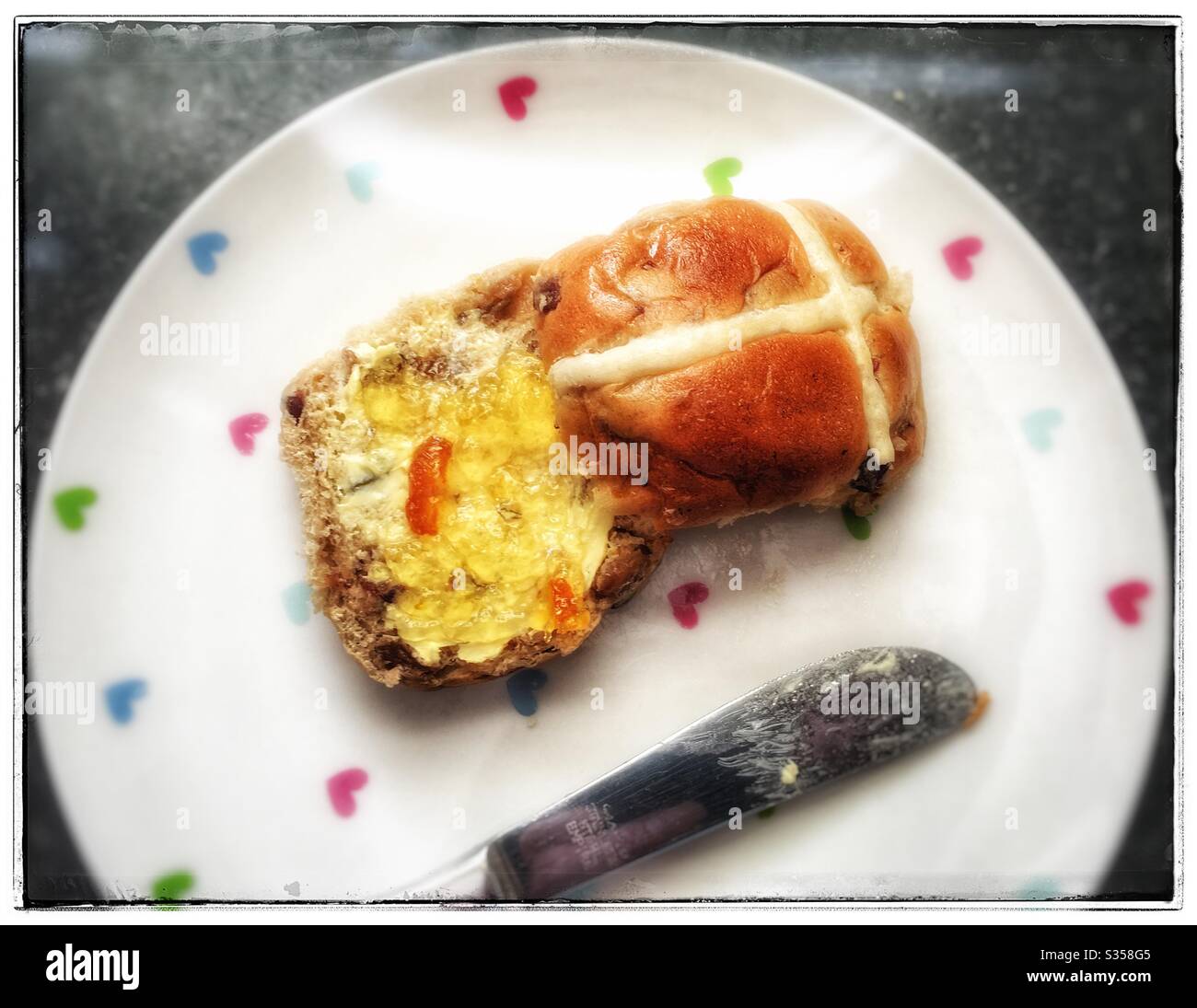 Mini hot cross bun with butter and marmalade Stock Photo - Alamy